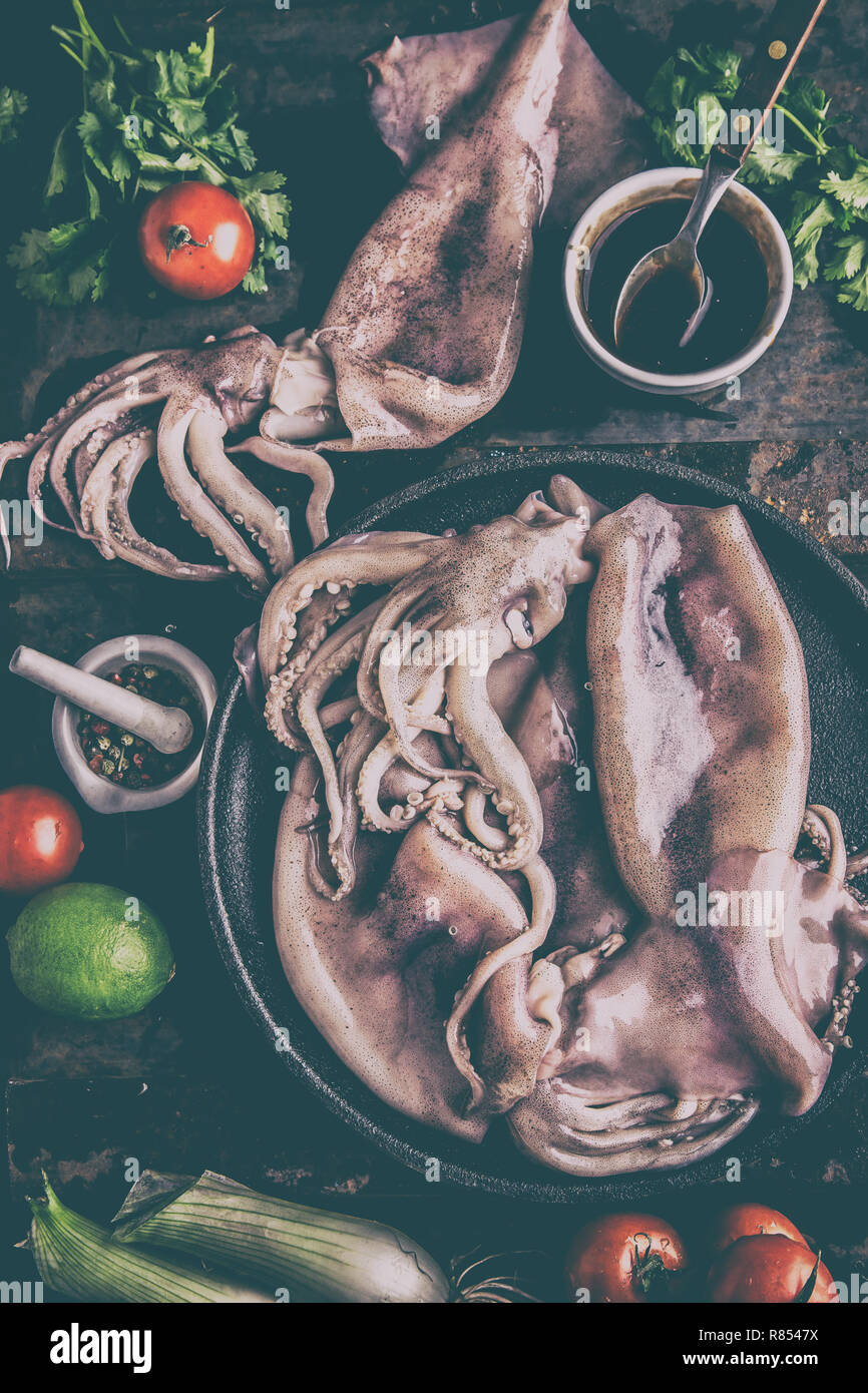 Seafood squid calamary. Fresh raw whole squid with tentacles on black ...