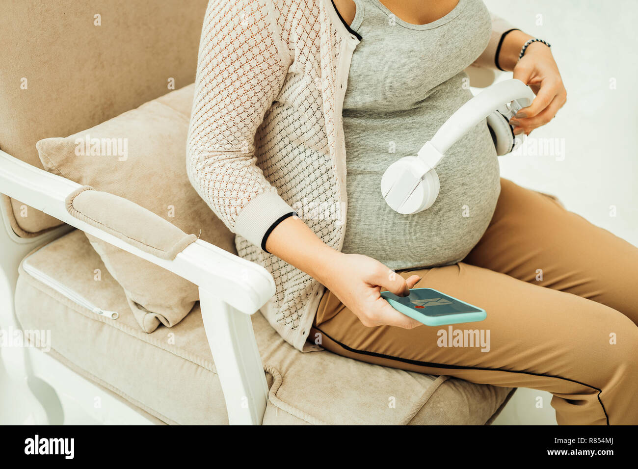 Communication by sound. A pregnant woman using a music to communicate ...