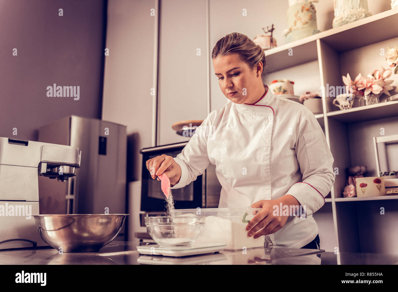 My work. Serious skilled chef standing in the kitchen while preparing ...