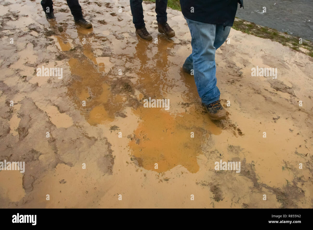People walking in the mud Stock Photo - Alamy