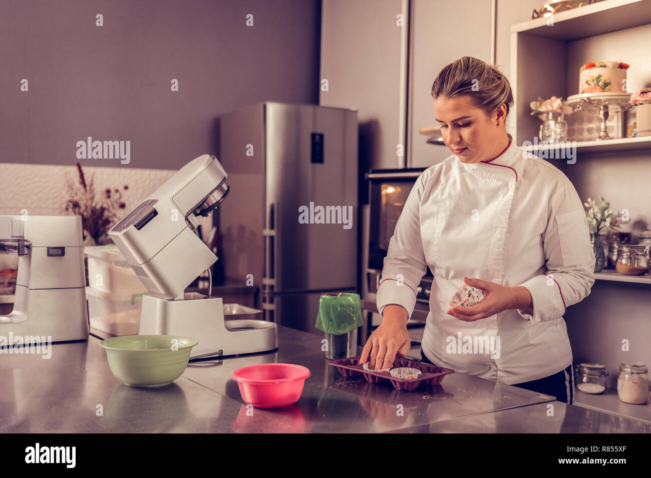Special recipe. Professional famous pastry chef standing in the kitchen ...