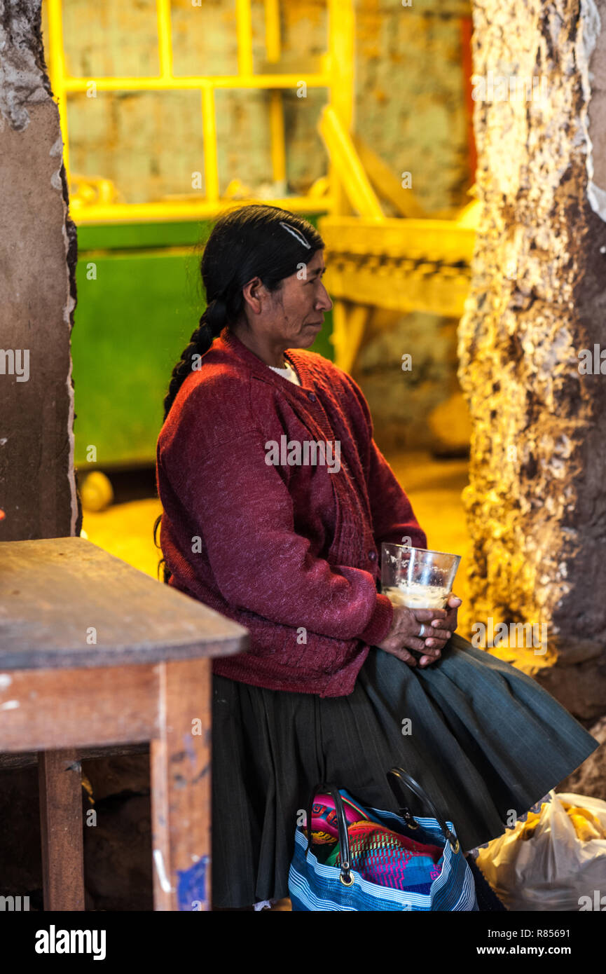 The woman is drinking chicha. Chicha- Inca beer is made from a special ...