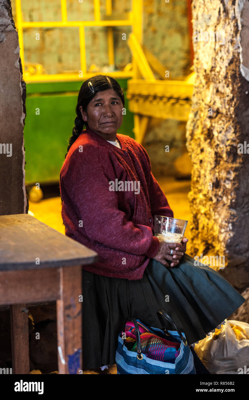 The woman is drinking chicha. Chicha- Inca beer is made from a special ...