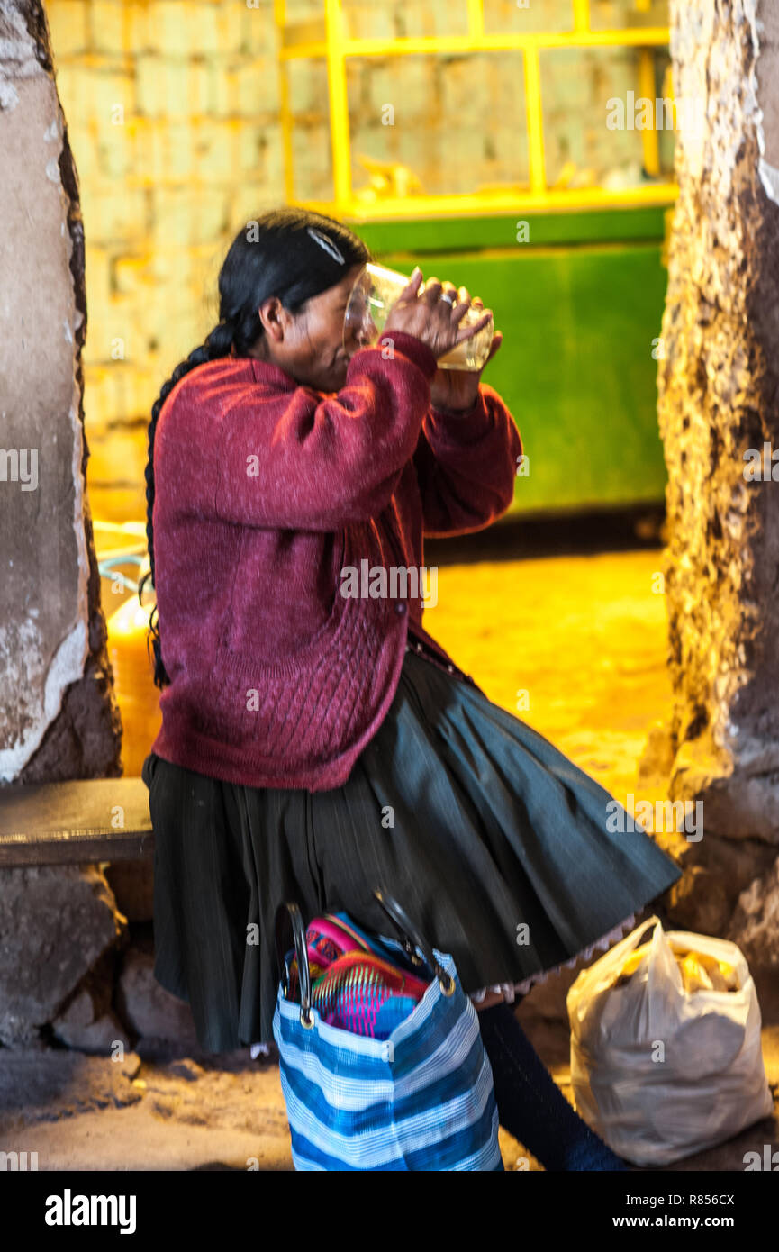 The woman is drinking chicha. Chicha- Inca beer is made from a special ...