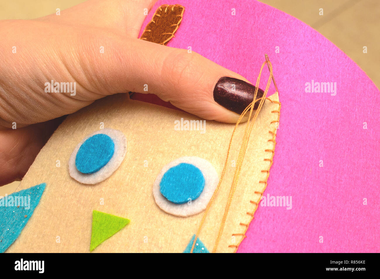 Sewing application of a owl of felt with a thread and a needle Stock ...