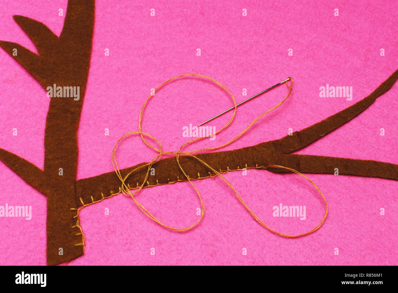 Sewing applique with felt thread and needle Stock Photo - Alamy