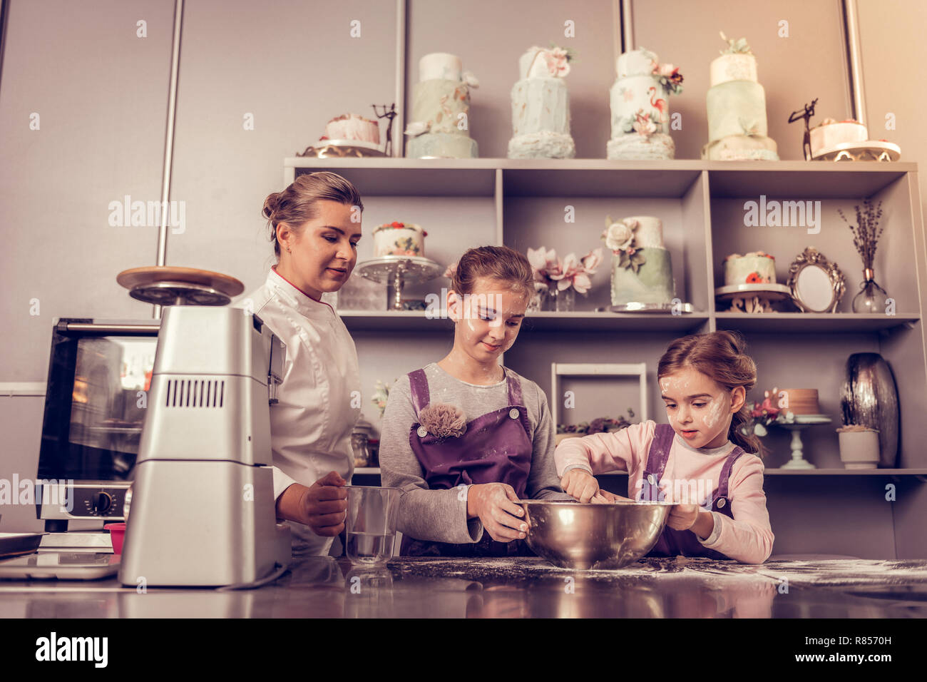 In the cooking academy. Professional female chef standing near the ...