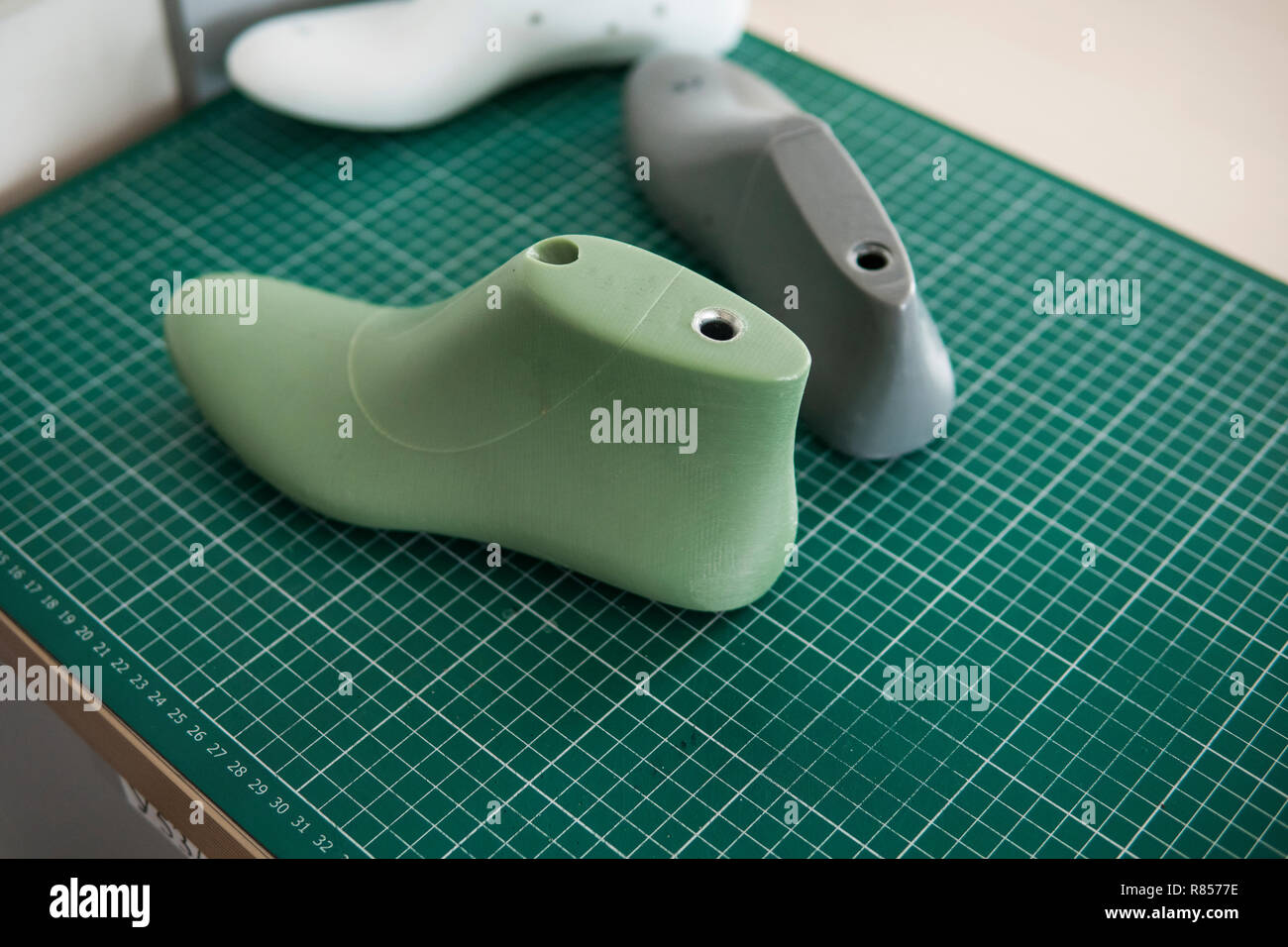 Three plastic last shoe on rubber secondary cut cutting mat, The ...