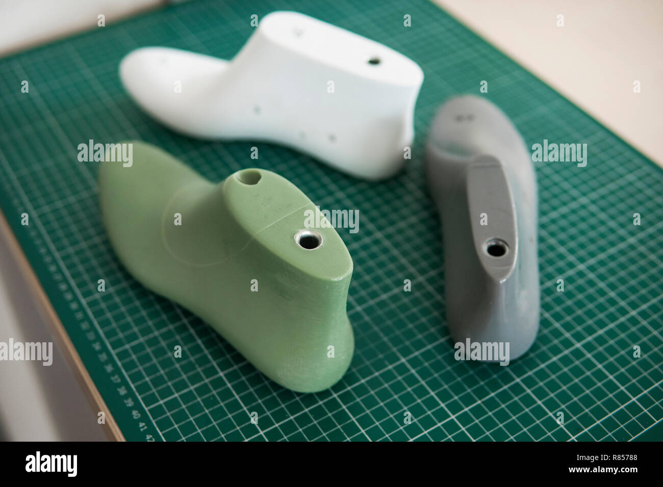 Three plastic last shoe on rubber secondary cut cutting mat, The ...