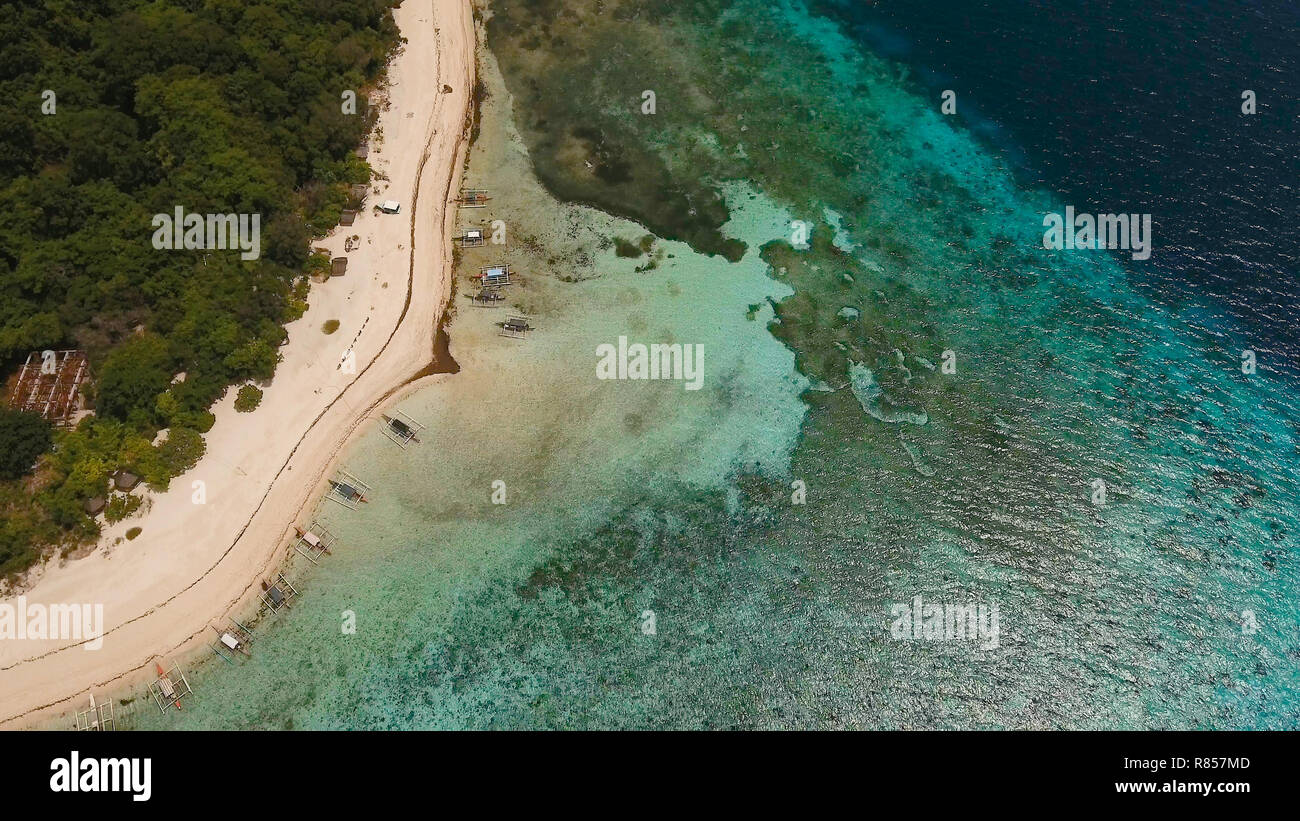 Aerial view of beautiful tropical island Mantigue with white sand beach ...