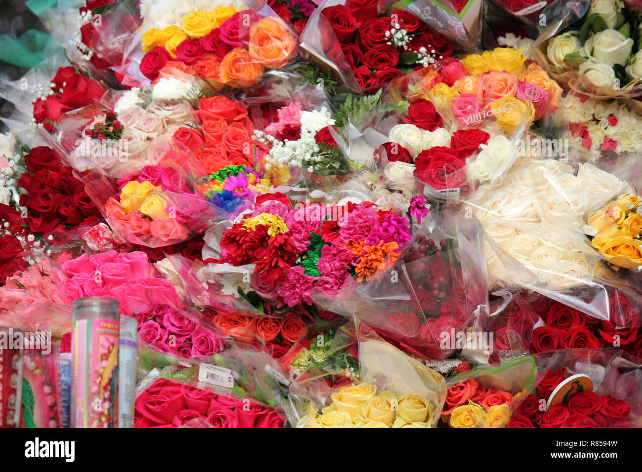 Stacks, piles, and a wall full of a variety of showy bouquets of ...