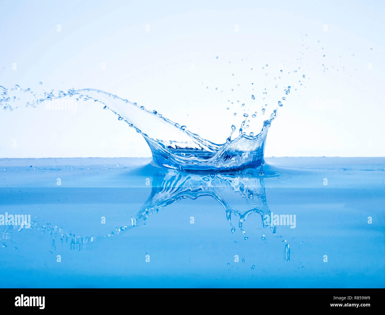 blue water splash crown shape on water surface isolated on white ...