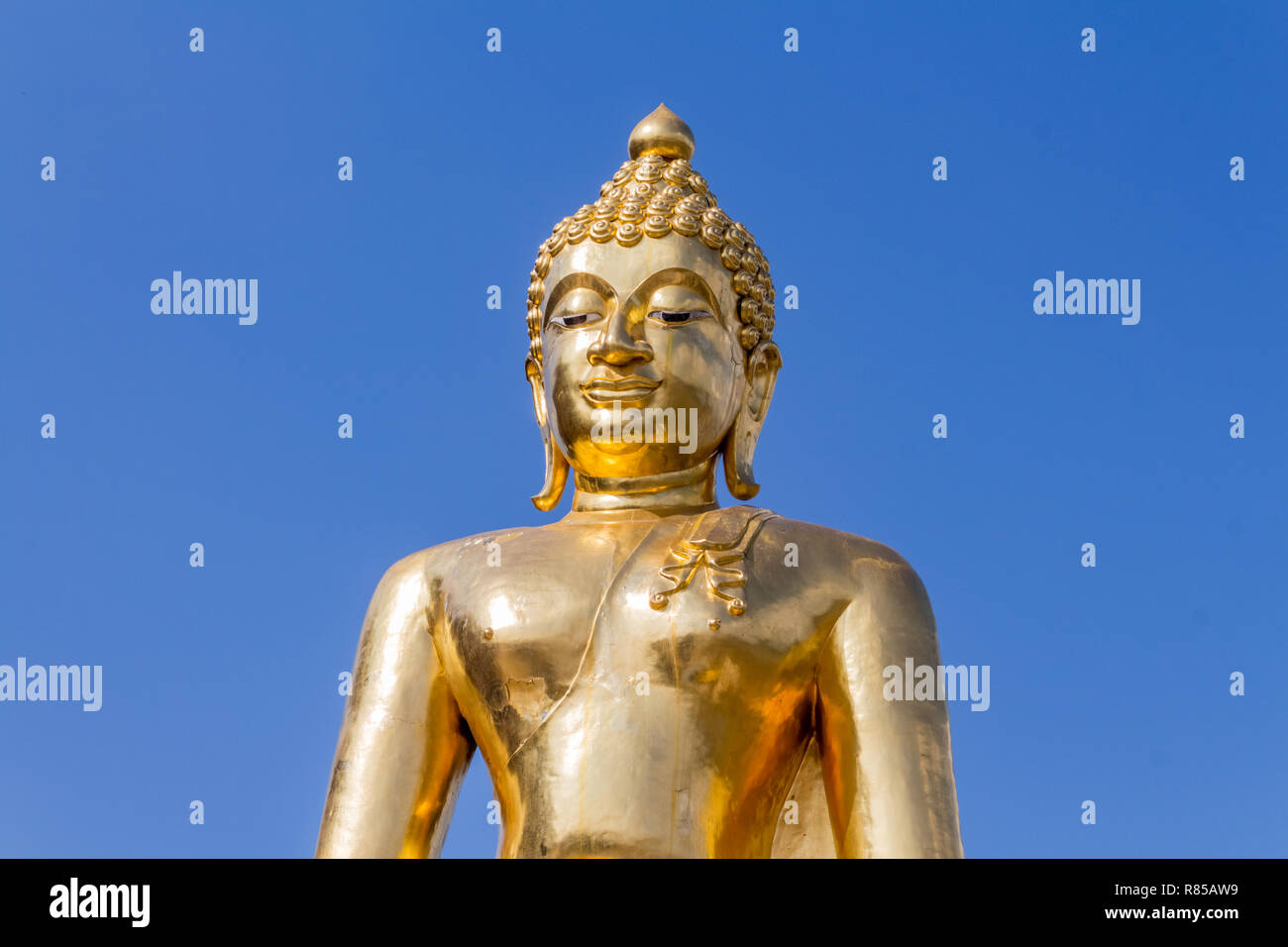Golden Buddha statue with blue sky background at the Golden Triangle ...