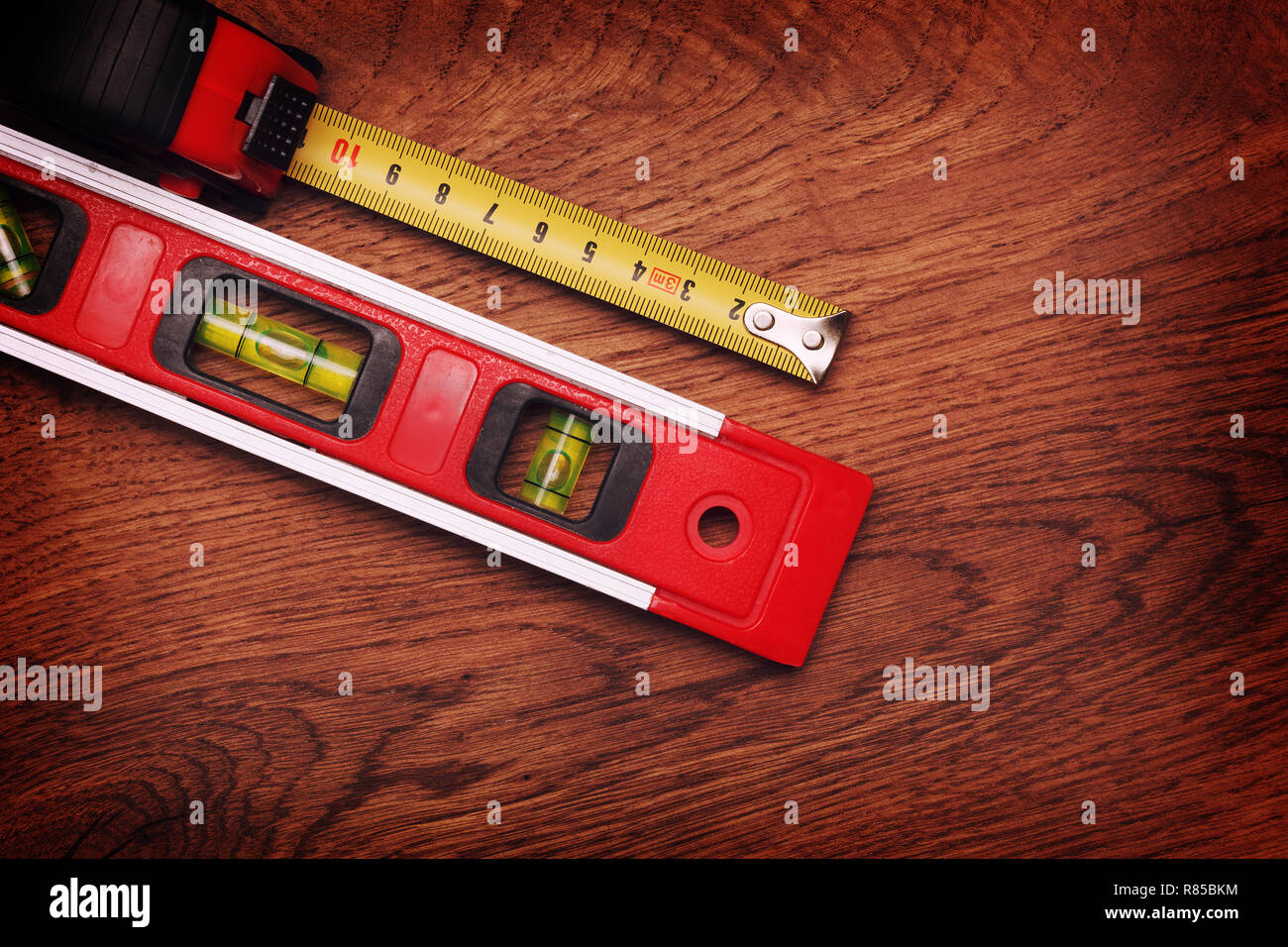 tape measure and building level on wooden background Stock Photo - Alamy