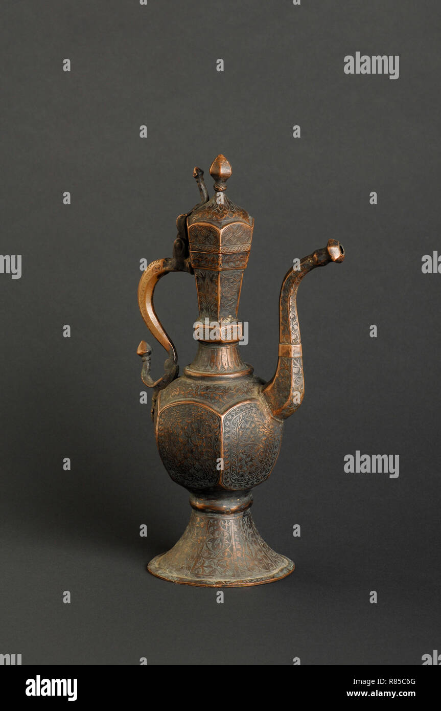 ancient oriental metal teapot on dark background. antique bronze ...