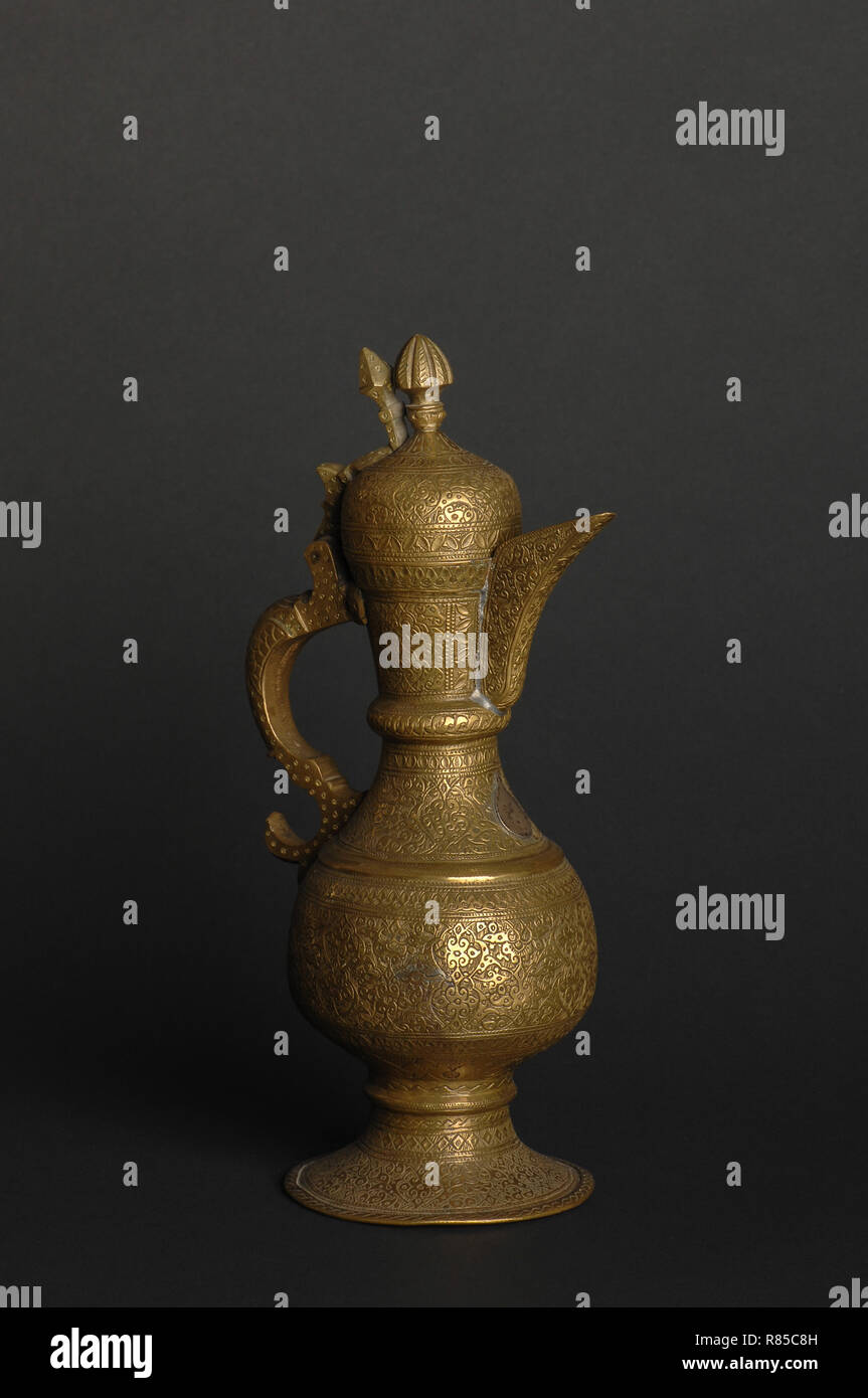 ancient oriental metal teapot on dark background. antique bronze ...