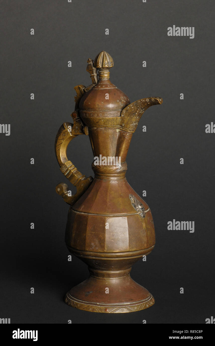 ancient oriental metal teapot on dark background. antique bronze ...