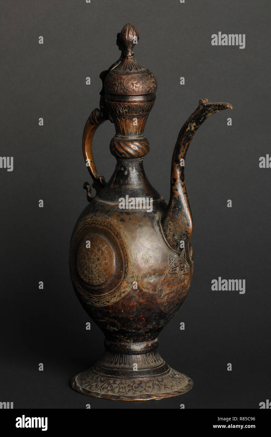ancient oriental metal teapot on dark background. antique bronze ...