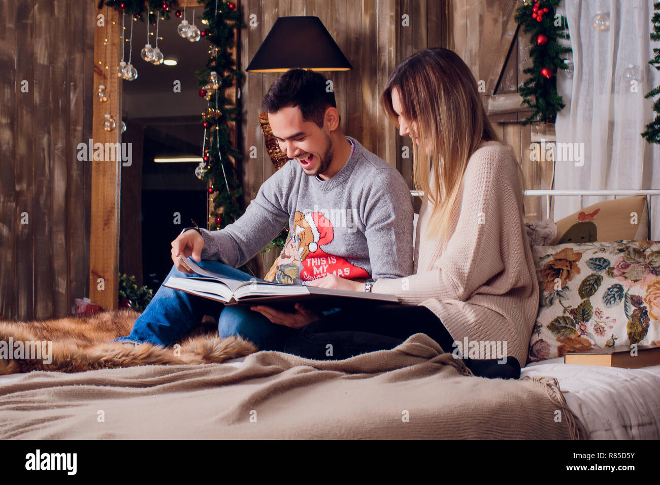 Spending nice time at home. Beautiful young loving couple bonding to ...