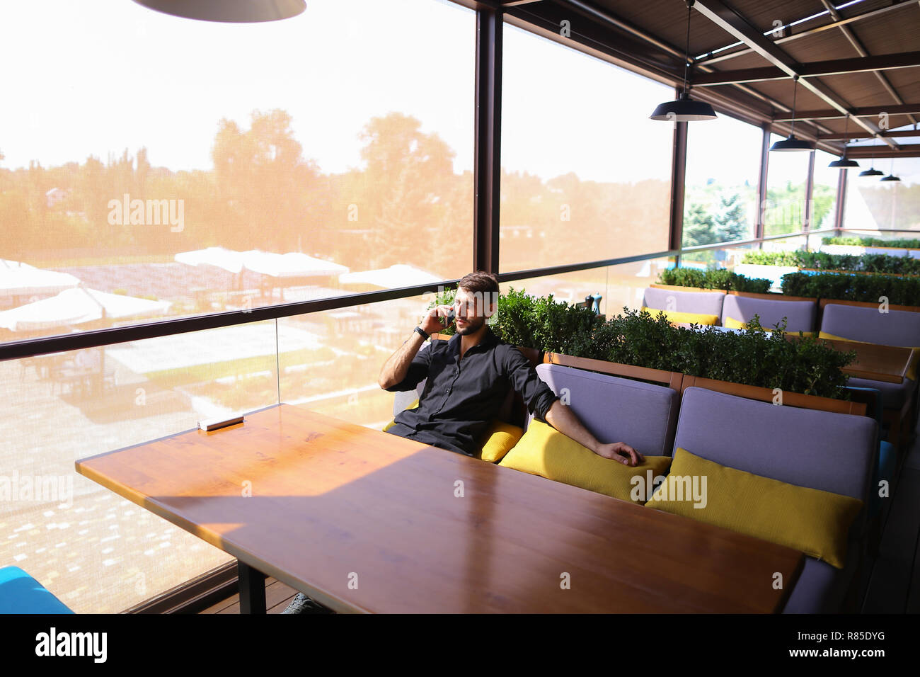 Prosperous man using smartphone for conversation an power bank a Stock ...