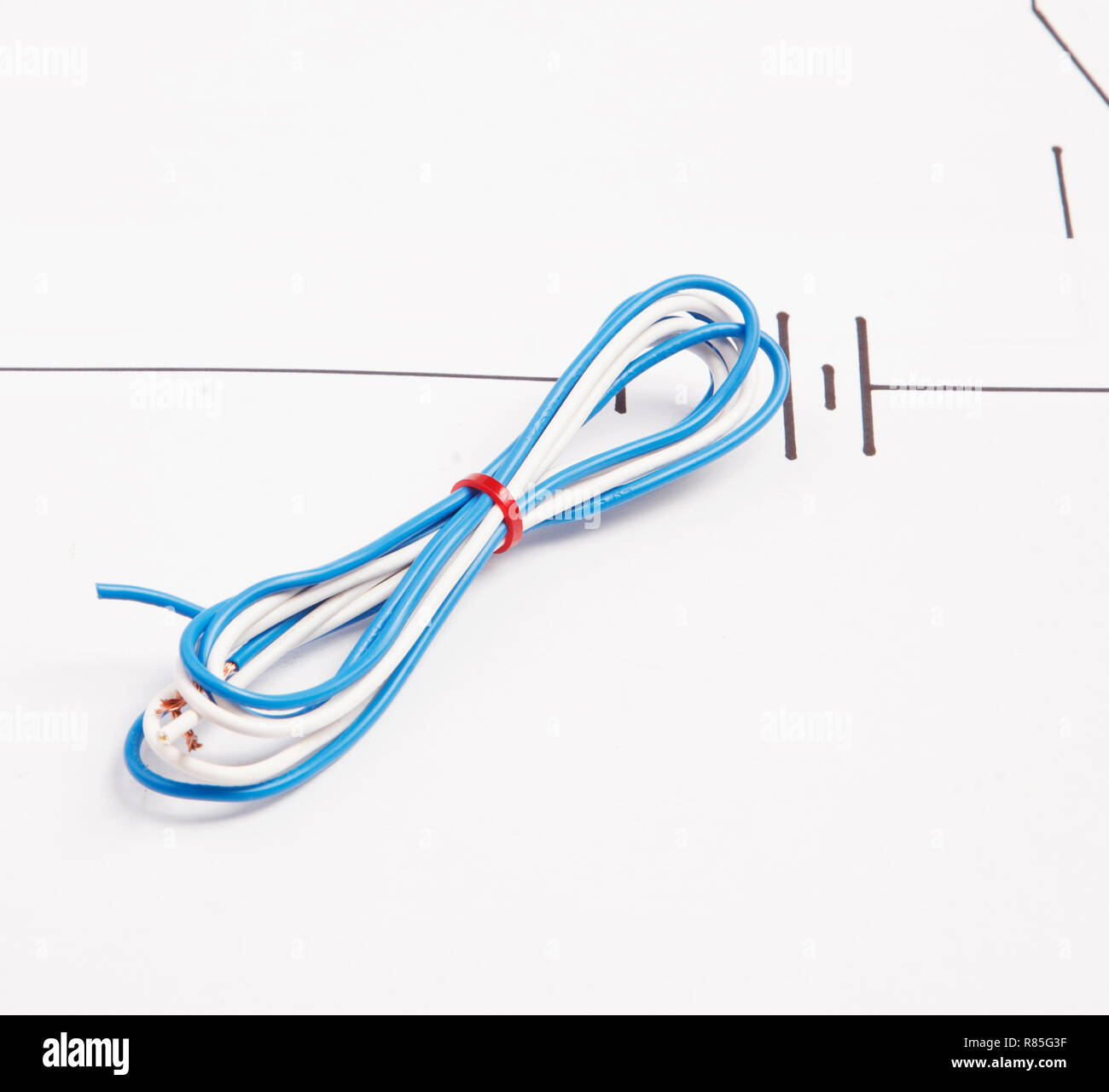 Electric wire on a background of the electric scheme Stock Photo - Alamy