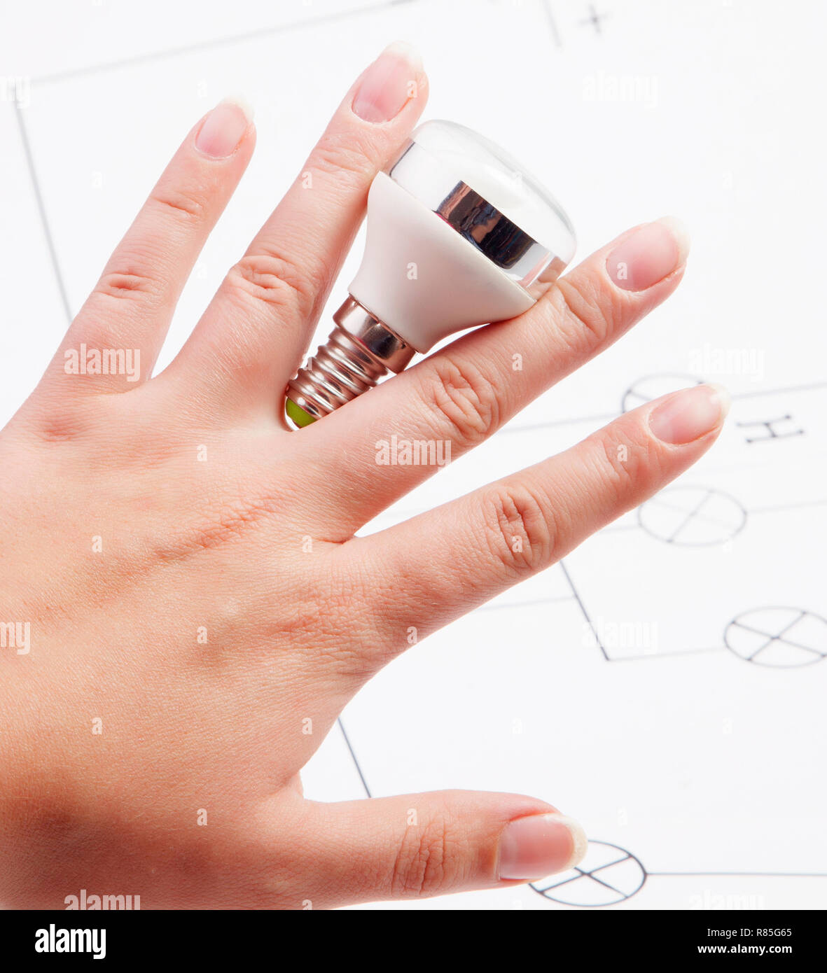 Energy saving fluorescent light bulb and hand Stock Photo - Alamy