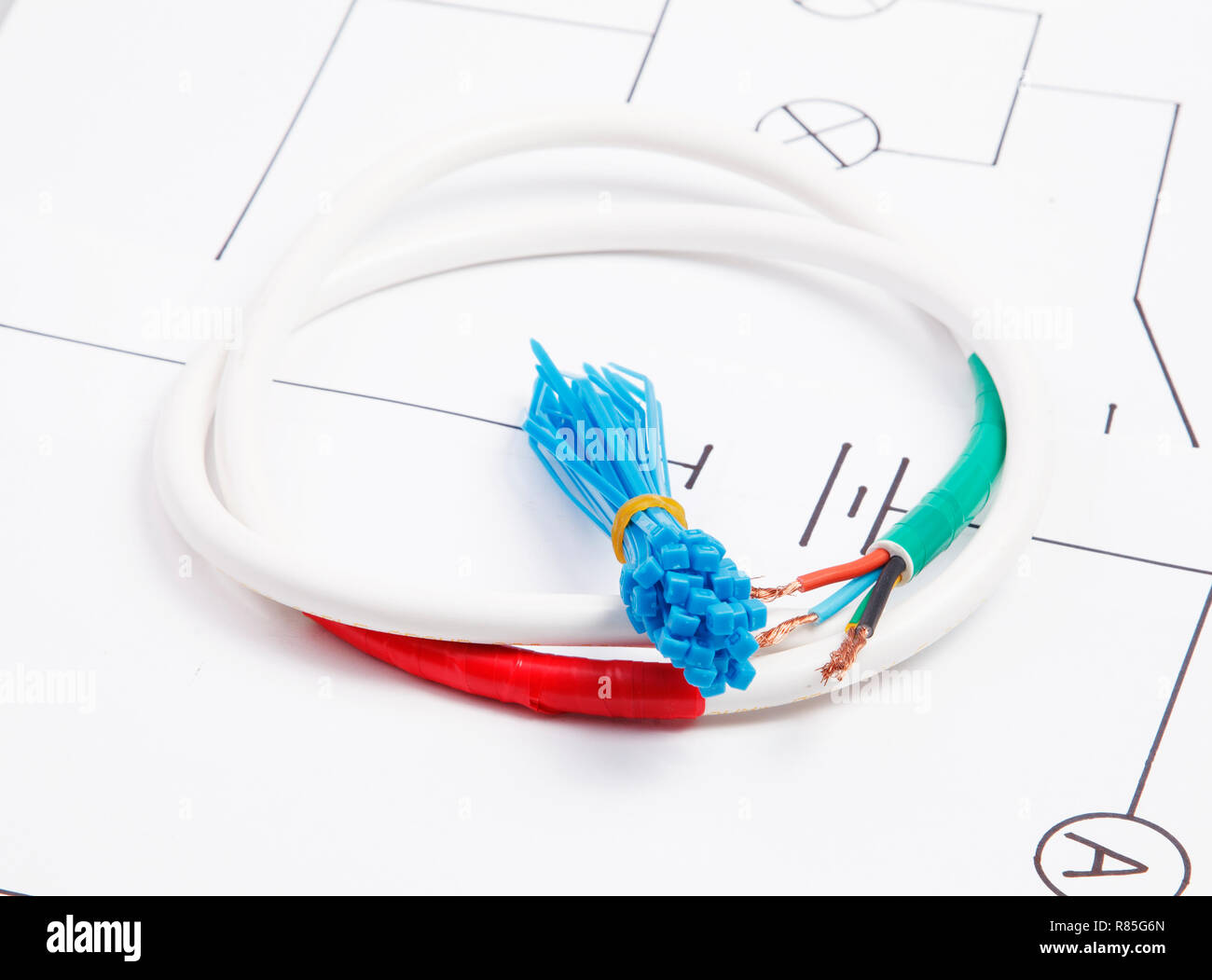 Plastic ties and electric cable on a background of the electric scheme ...