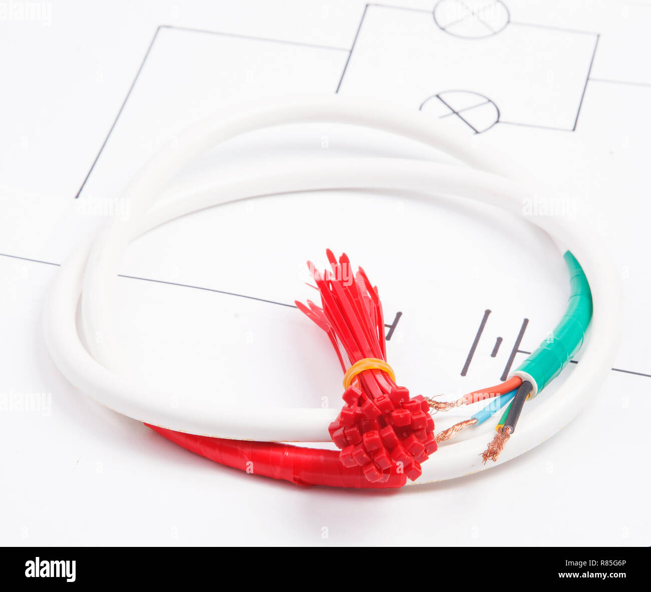 Plastic ties and electric cable on a background of the electric scheme ...