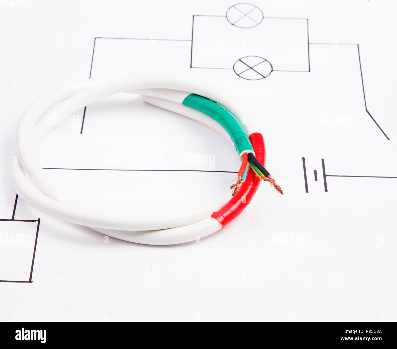 Electric wire on a background of the electric scheme Stock Photo - Alamy