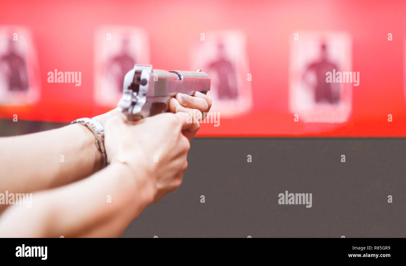 Woman Both Hands holding magnum gun, index finger on trigger, aiming ...