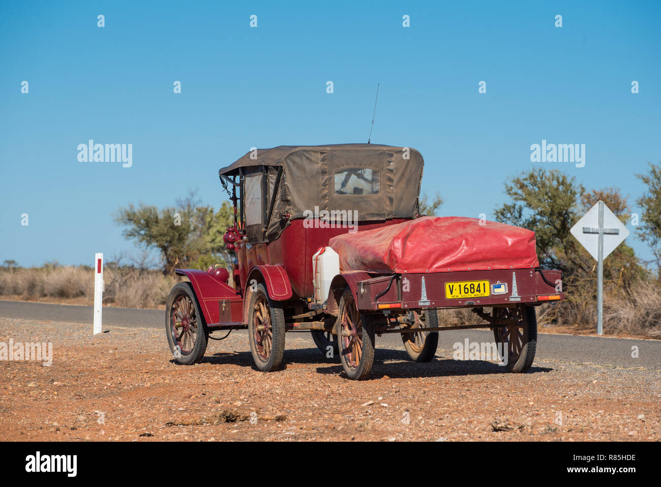 Vintage Model T Ford and vintage camper trailer travel through outback ...