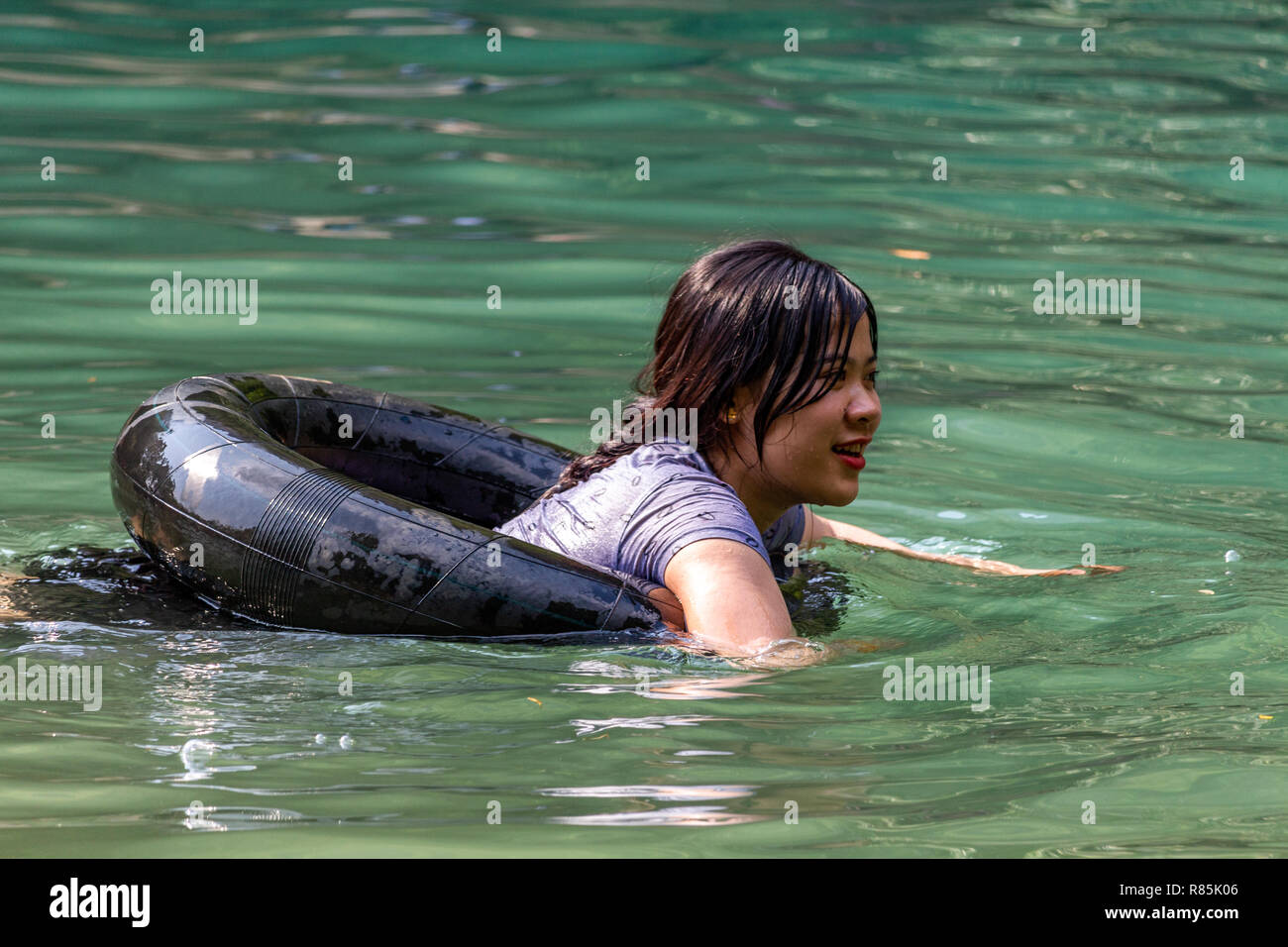 Thakhek, Laos - April 20, 2018: Local girl with tubing equimpent in the ... Thakhek, Laos - April 20, 2018: Local girl with tubing equimpent in the ...
