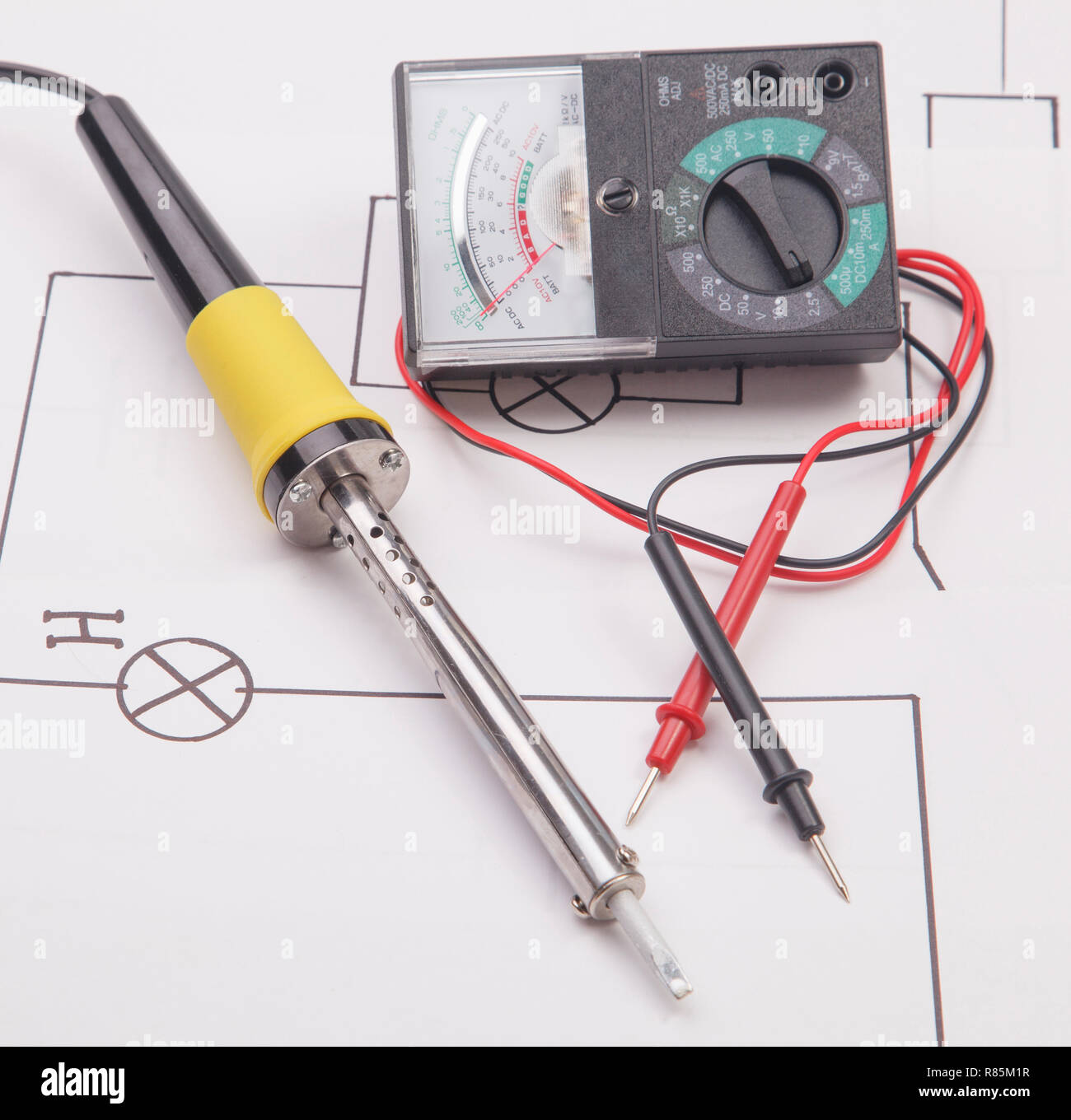 Analogue multimeter with probe and on a background of the electric ...