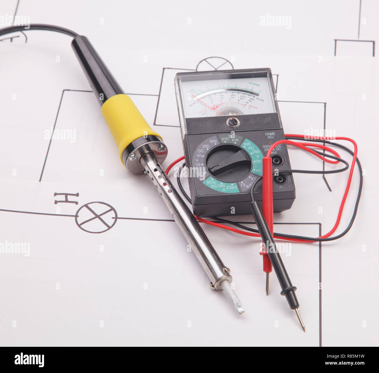 Analogue multimeter with probe and on a background of the electric ...