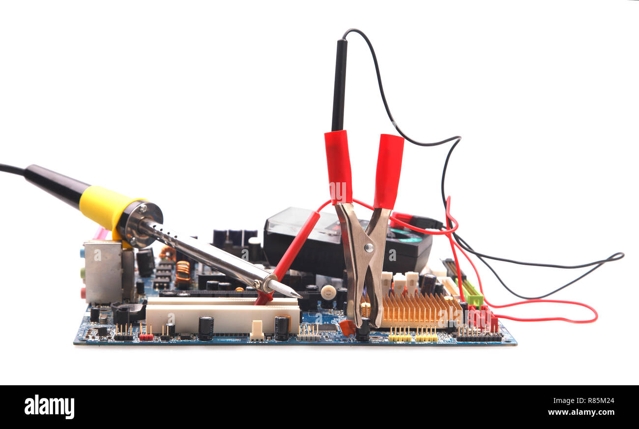 Soldering iron and electronic circuit board on a background of the ...
