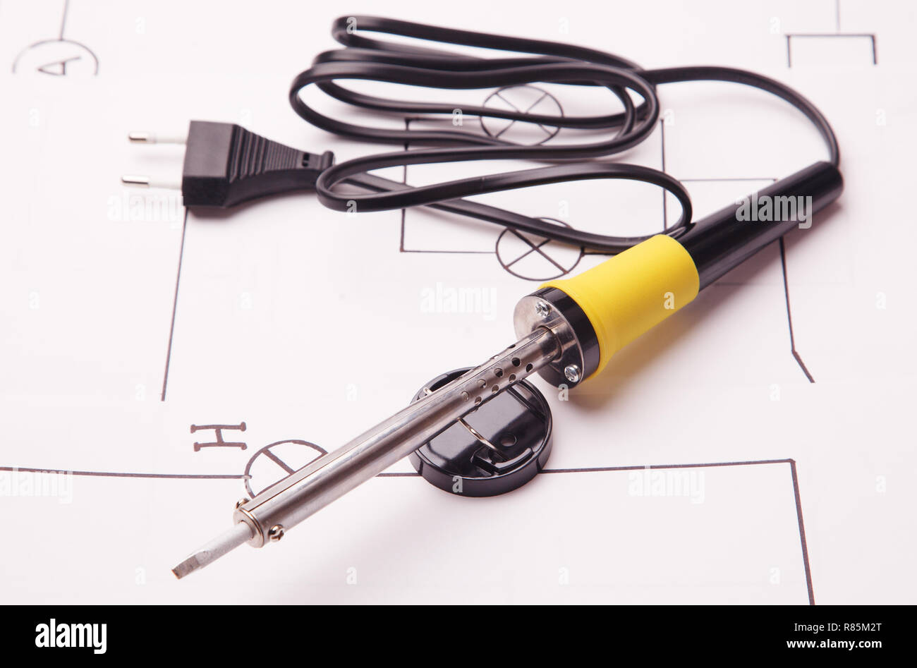 Soldering iron on a background of the electric scheme Stock Photo - Alamy