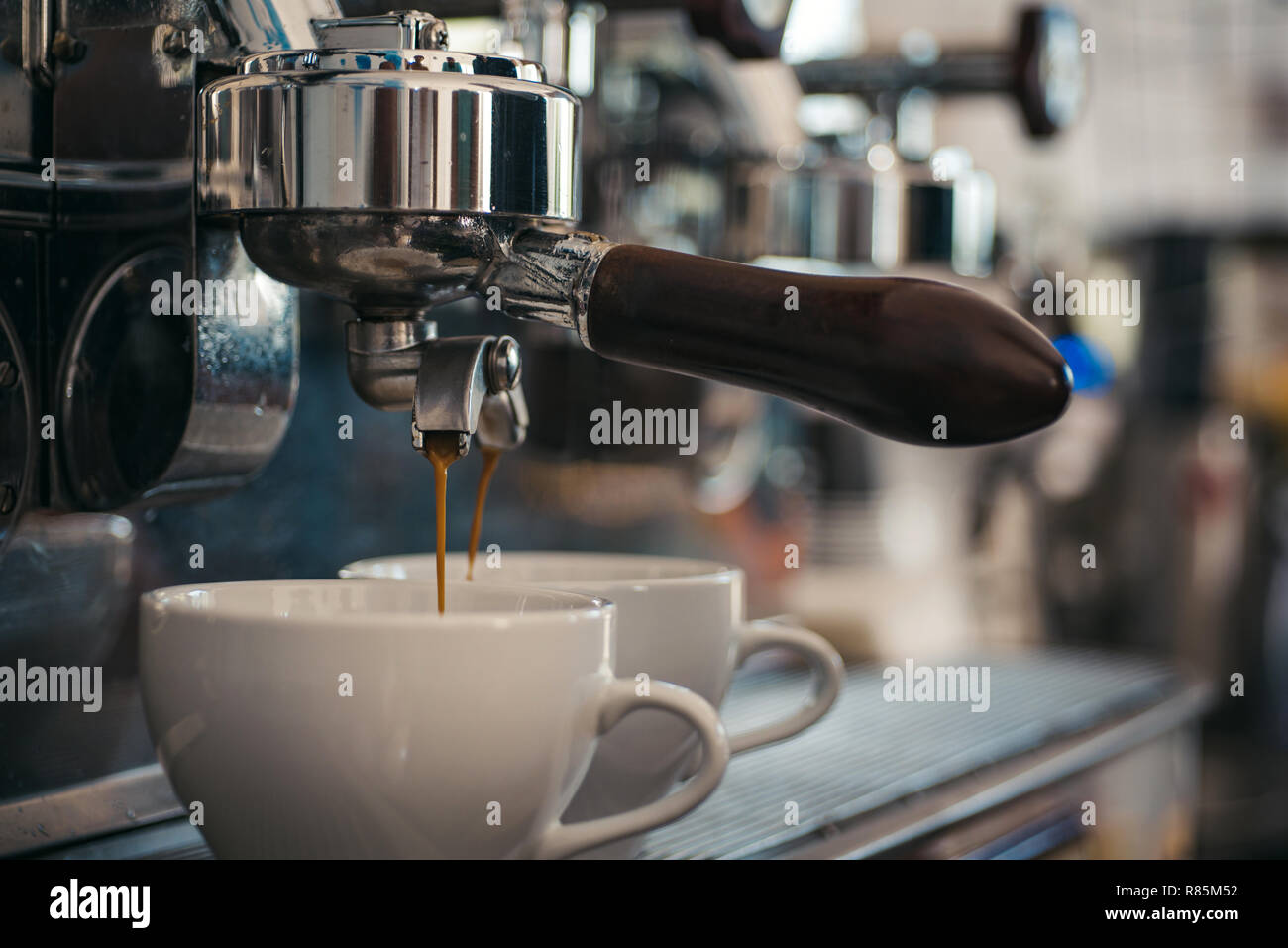 Enjoy superior coffee. Making espresso with portafilter. Small cups to ...