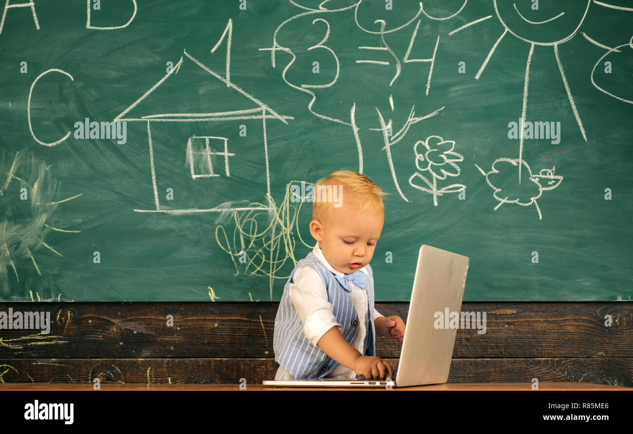 Child use laptop to get access to online education. Little boy learn ...