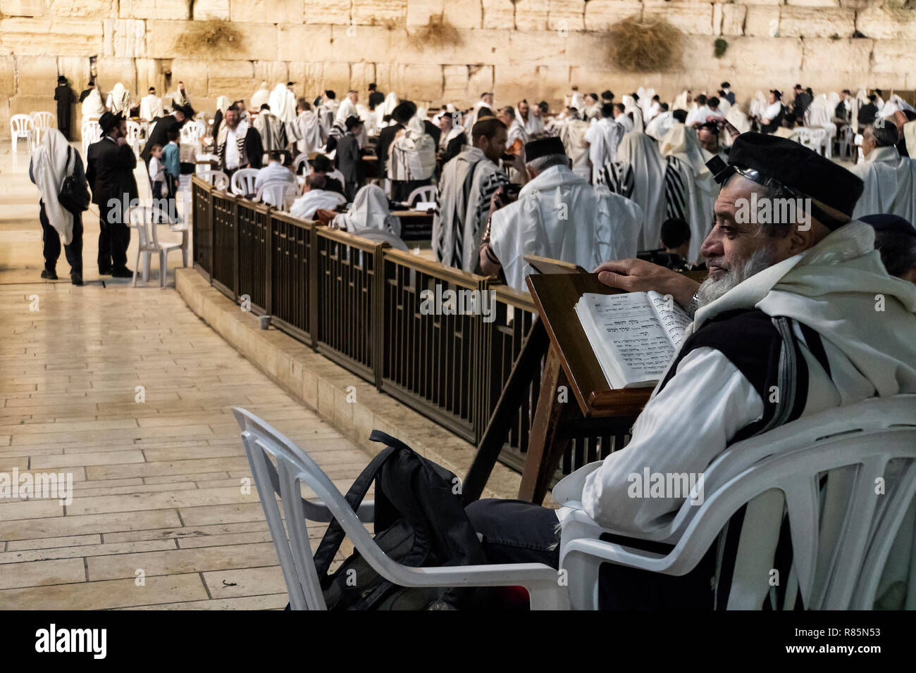 Religious orthodox jew praying at the Western wall and reads the Torah ...