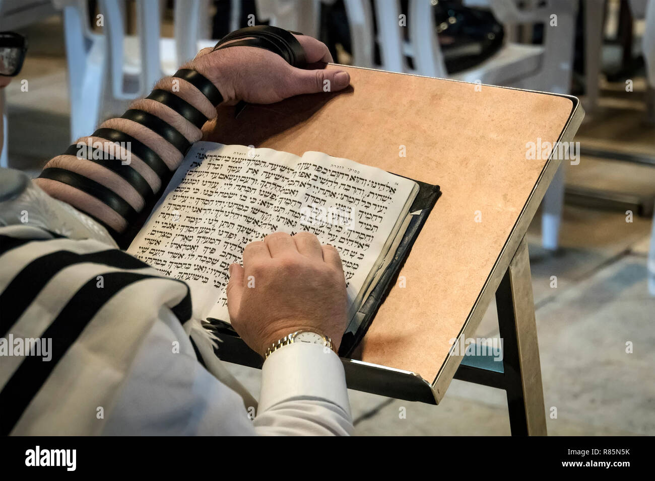 Religion Jew reading prayer book. Torah on the table in front of the ...