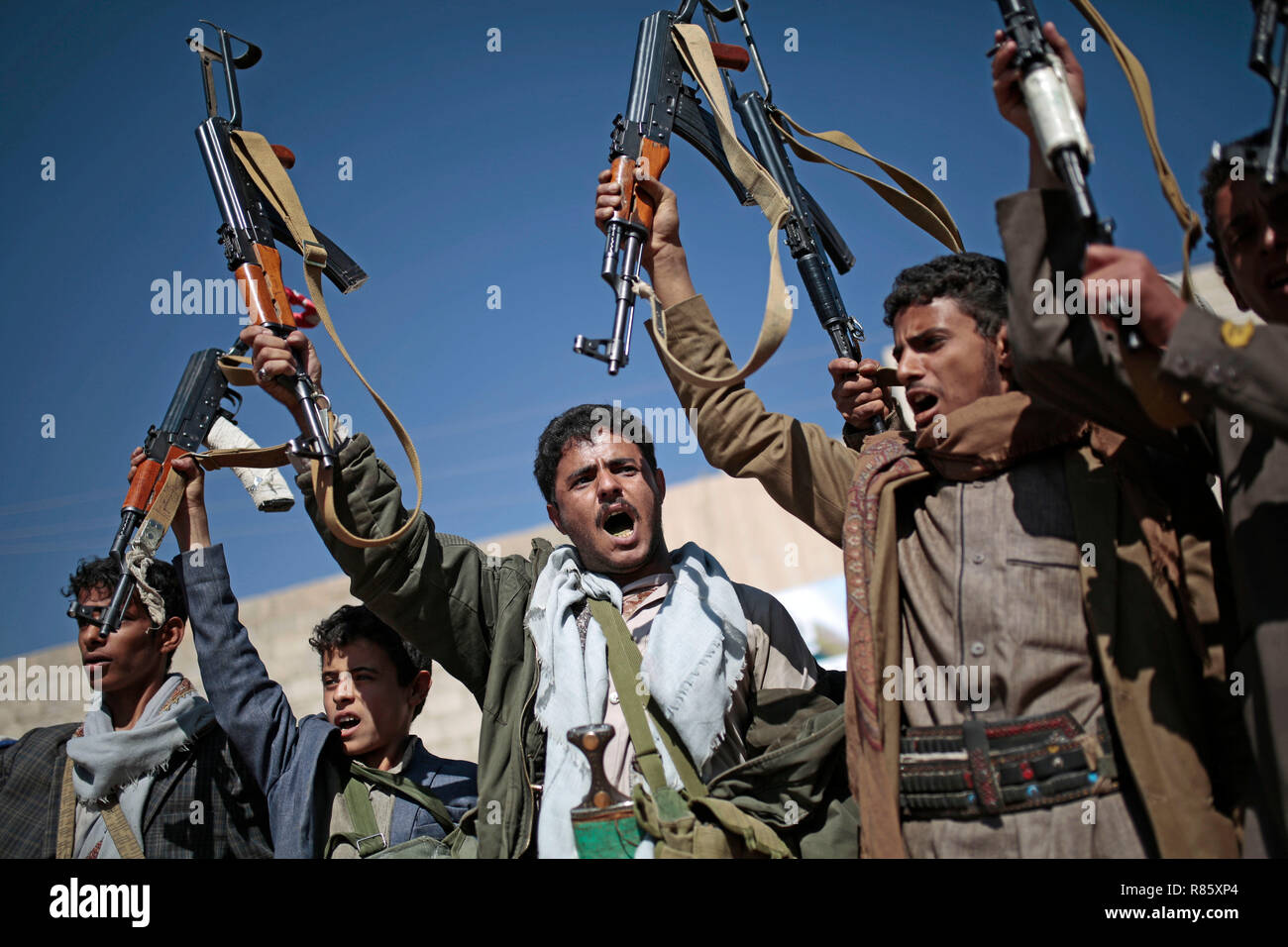 Sanaa, Yemen. 13th Dec, 2018. Houthi rebel fighters hold up their ...
