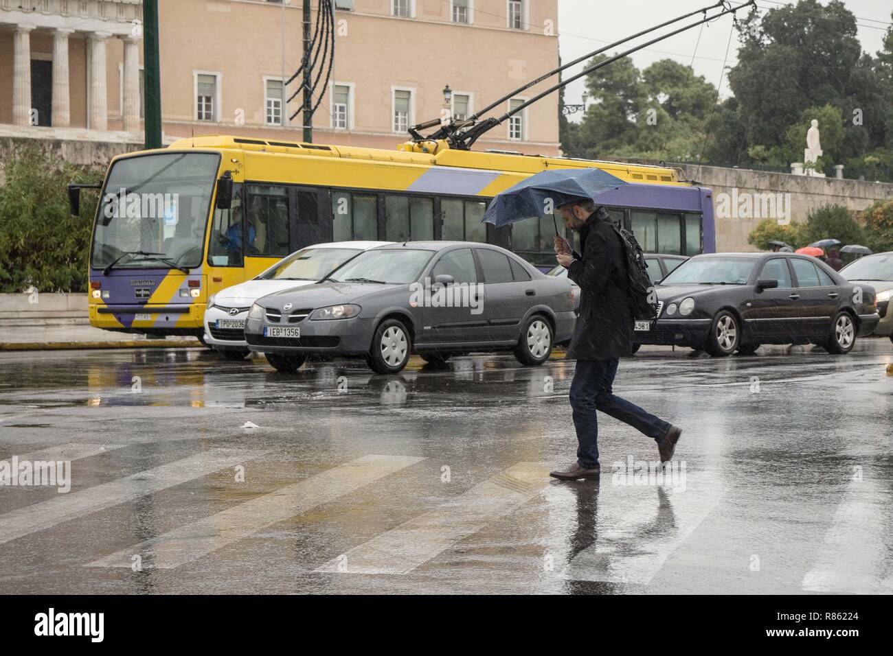 Athens, Greece. 13th Dec, 2018. A man seen with an umbrella at the ...