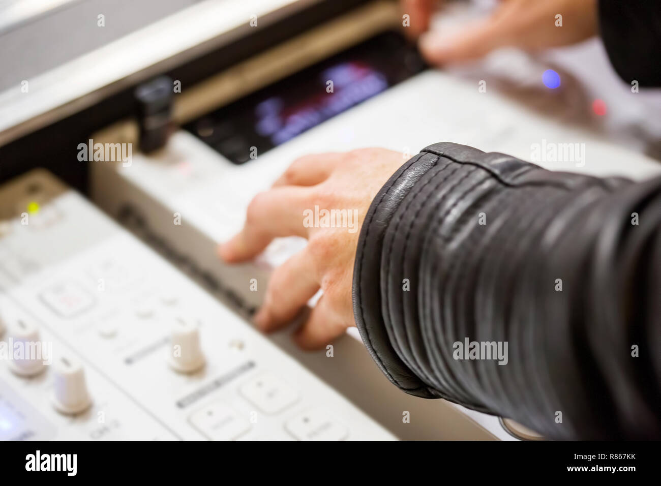 Sound engineer using audio sliders Stock Photo - Alamy