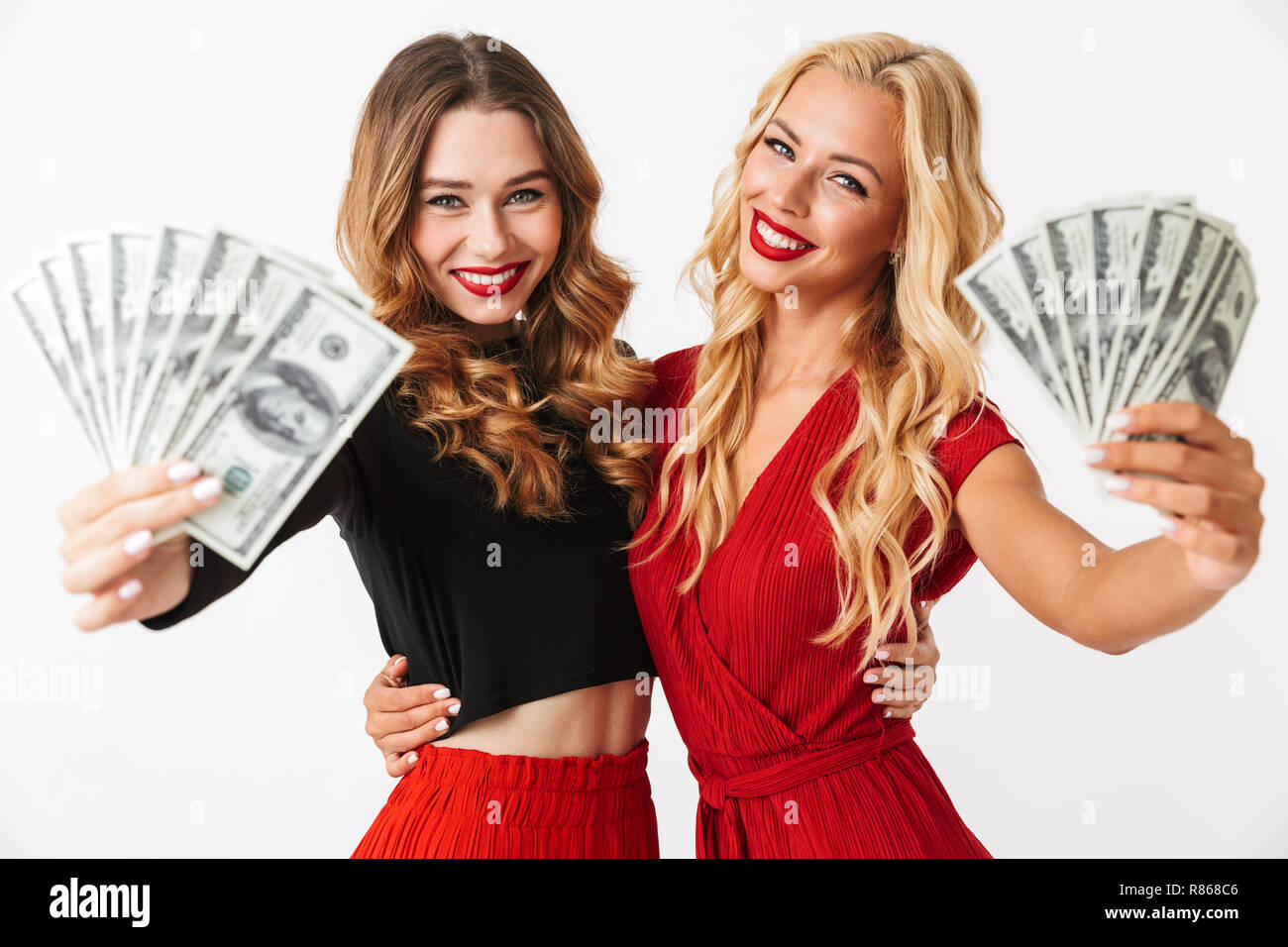 Portrait of two happy young smartly dressed women wearing makeup ...