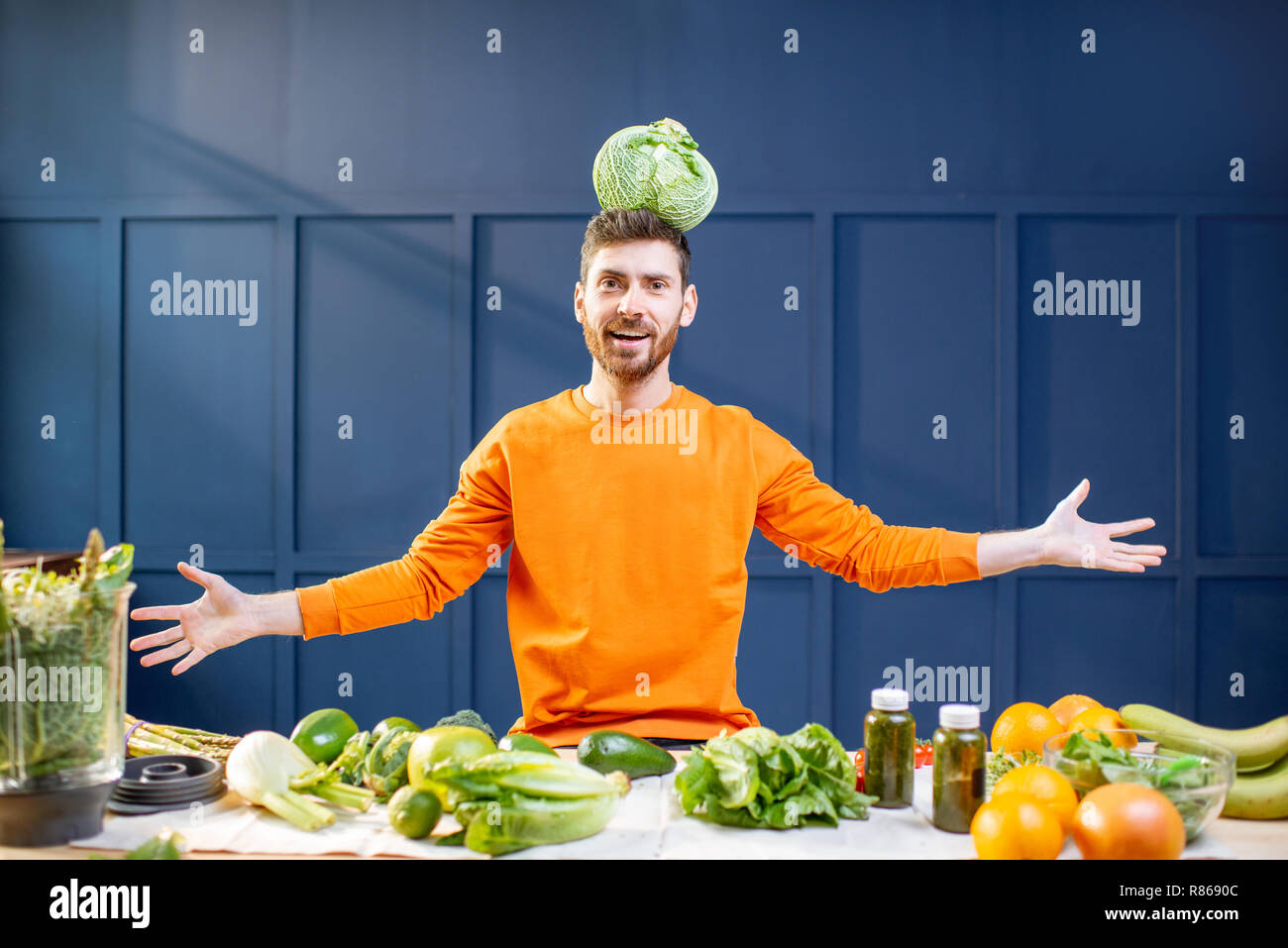 Conceptual portrait of a vegetarian man with fresh green vegetables ...