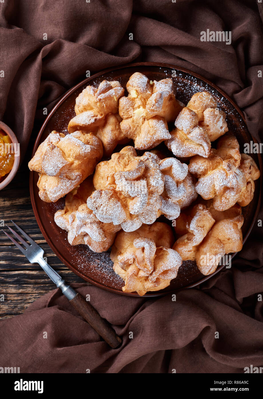 Profiteroles with custard cream filling served for breakfast on a ...