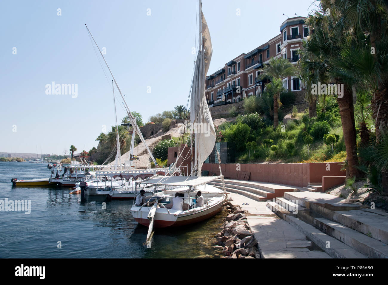 Egyptian feluccas (boats) moored on the Nile at the Old Cataract Hotel ...