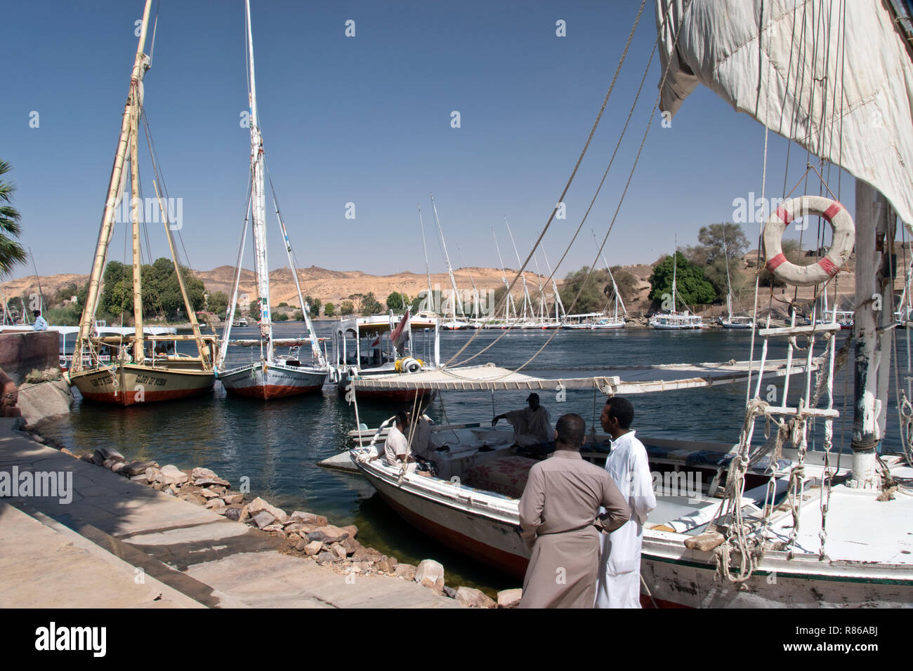 Egyptian feluccas (boats) moored on the Nile at the Old Cataract Hotel ...