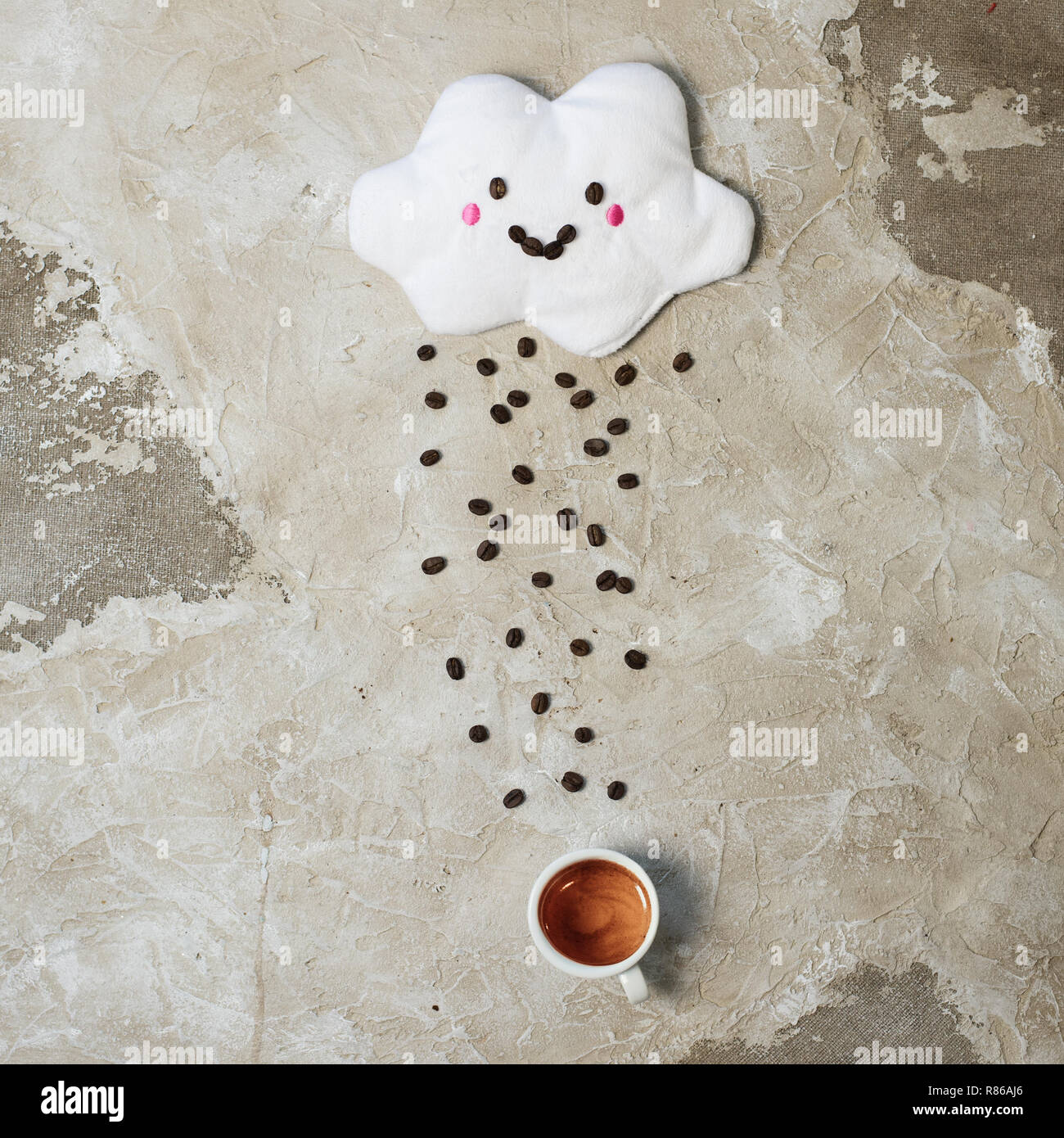 White cloud with happy face pouring rain of roasted beans into cup of ...