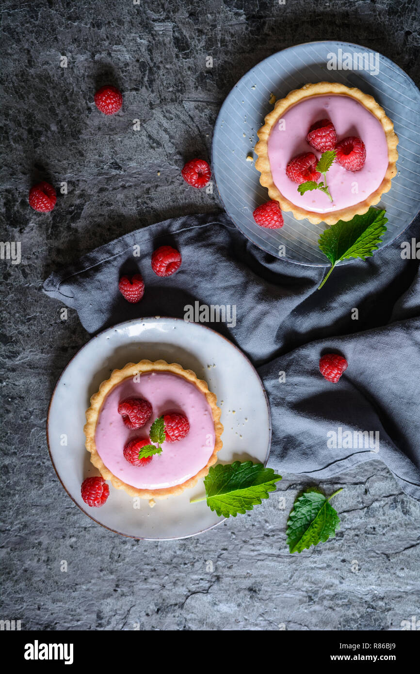 Sweet tartlets filled with raspberry mascarpone cream Stock Photo - Alamy